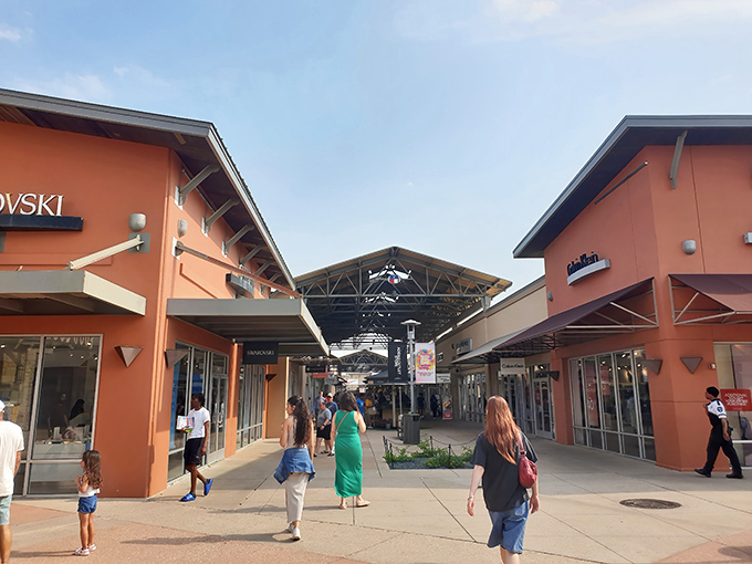 Round Rock Premium Outlets sprawls like a shopper's dream, where orange buildings house endless treasures waiting to be discovered.