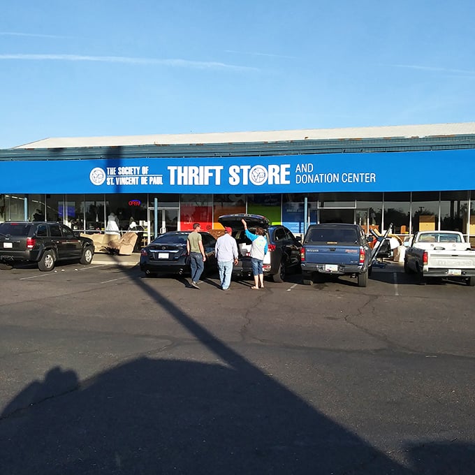 The bright blue facade of St. Vincent de Paul's thrift store beckons like a bargain-hunter's oasis in the desert heat.