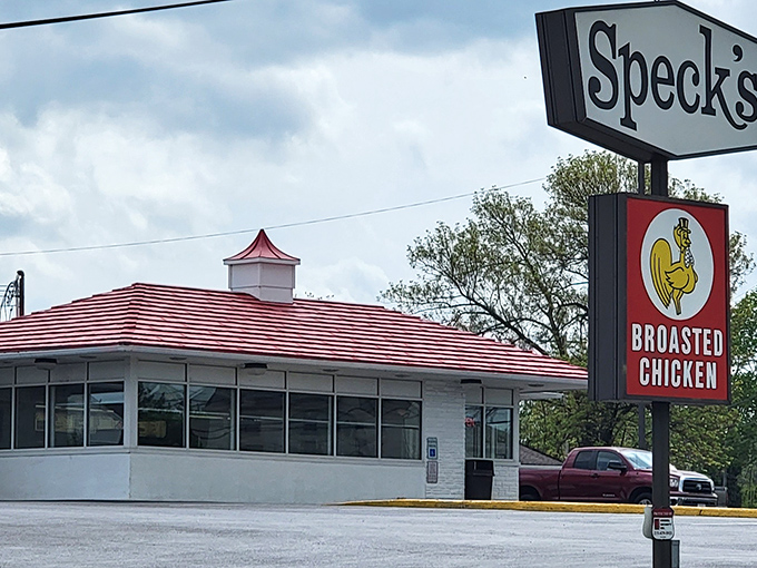 Speck's iconic red-roofed drive-in looks like it time-traveled from 1955. The broasted chicken inside is worth every mile of the journey!