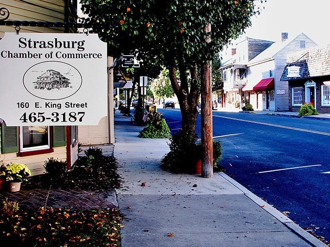 Strasburg's Chamber of Commerce sign stands like a friendly greeter, promising small-town charm and big-hearted welcomes just steps away.
