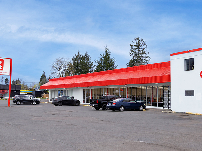 SuperThrift's iconic red roof beckons like a lighthouse for bargain hunters navigating Portland's secondhand seas.
