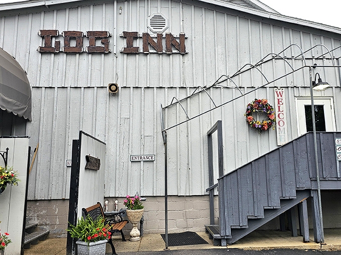 The Log Inn's weathered white exterior hides a fried chicken paradise inside. Like finding a treasure map in your grandma's attic!