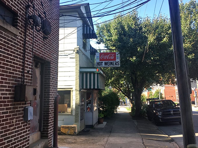 The tiny storefront of The Roast Grill stands like a time capsule on Raleigh's street. That Coca-Cola sign has probably guided hungry folks here since before color TV!