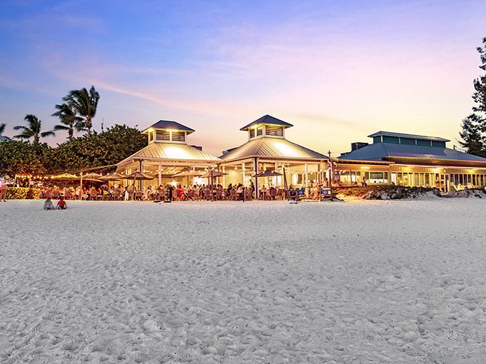 Paradise found! The Sandbar's beachfront pavilions glow like lanterns as another perfect Florida sunset begins its nightly show.