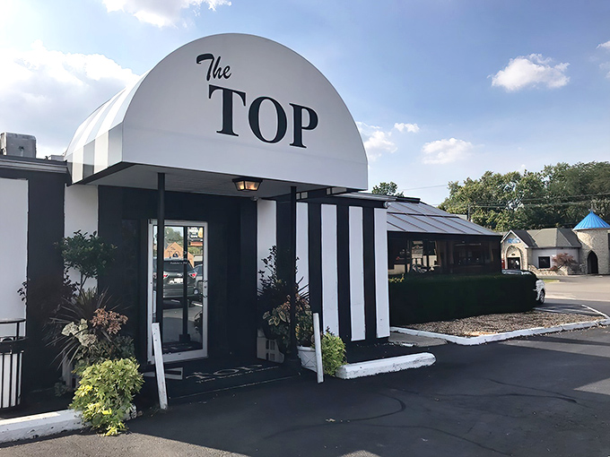 That distinctive curved sign says it all - The Top doesn't need fancy frills when excellence speaks volumes.