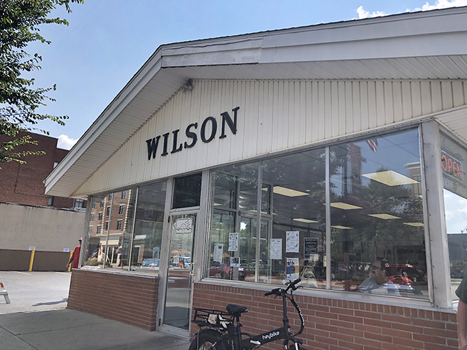 Wilson's iconic storefront stands as a time capsule of American diner culture, promising simple pleasures done perfectly.