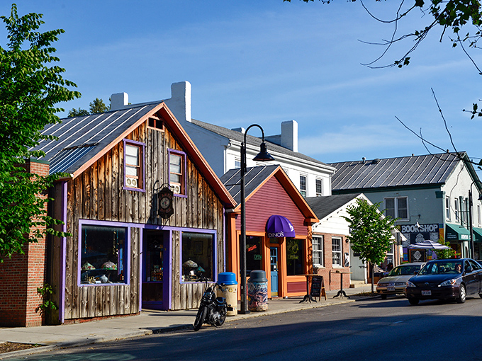 Wooden wonders and purple portals! Yellow Springs' storefronts pop like a Wes Anderson film set where your Social Security check feels right at home.