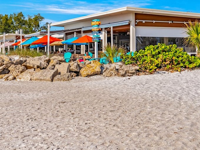Colorful umbrellas dot the sand like confetti at this beachfront gem where the line between restaurant and shoreline blurs deliciously.