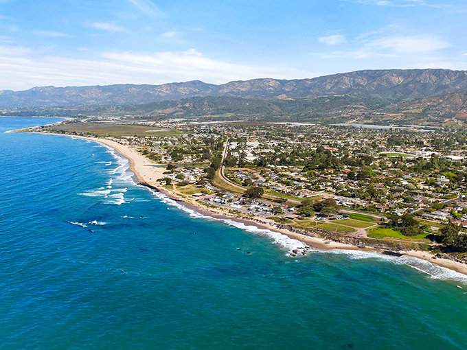 Mountain backdrops frame this peaceful coastal haven where surfers and sunbathers share miles of pristine, family-friendly shoreline.