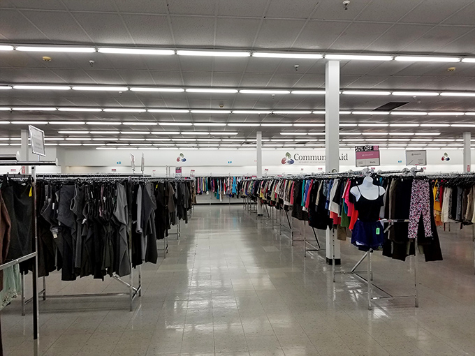 Inside Community Aid, endless clothing racks create a bargain hunter's paradise where designer dreams meet wallet-friendly reality.