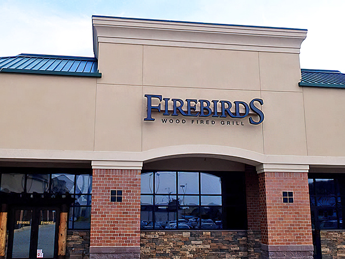 The bold Firebirds sign beckons hungry travelers like a lighthouse for steak lovers navigating dinner options.