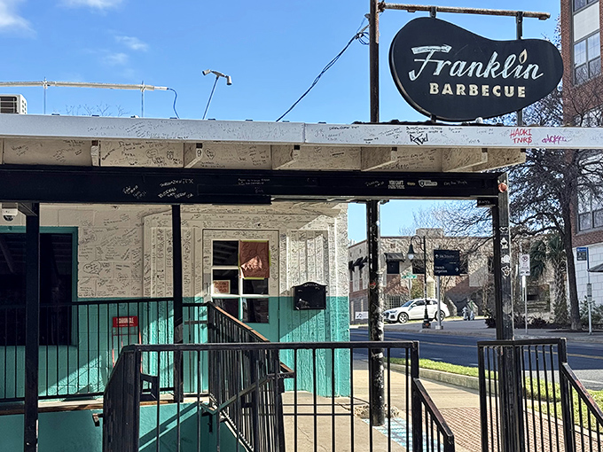 Franklin's iconic sign beckons like a lighthouse for hungry souls seeking the holy grail of Texas brisket.