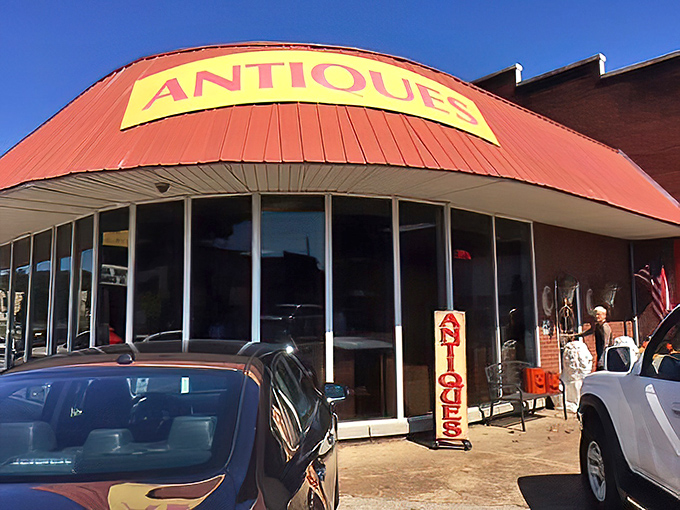That yellow "ANTIQUES" sign might as well say "ADVENTURE" &ndash; each visit promises new discoveries behind those windows.