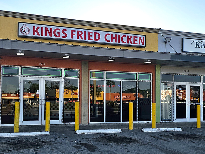 Yellow bollards guard this chicken fortress like sentries protecting culinary gold inside those glass doors.