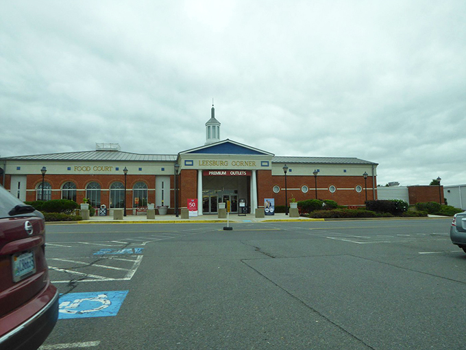 Leesburg Corner's brick facade and welcoming entrance promise a day of wallet-friendly retail therapy under Virginia skies.