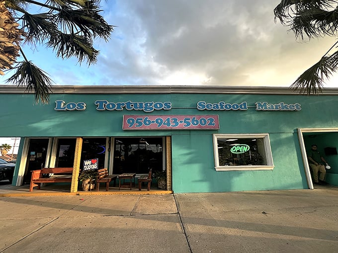 Wooden benches and an "OPEN" sign - the universal language for "get ready for some seriously good seafood."