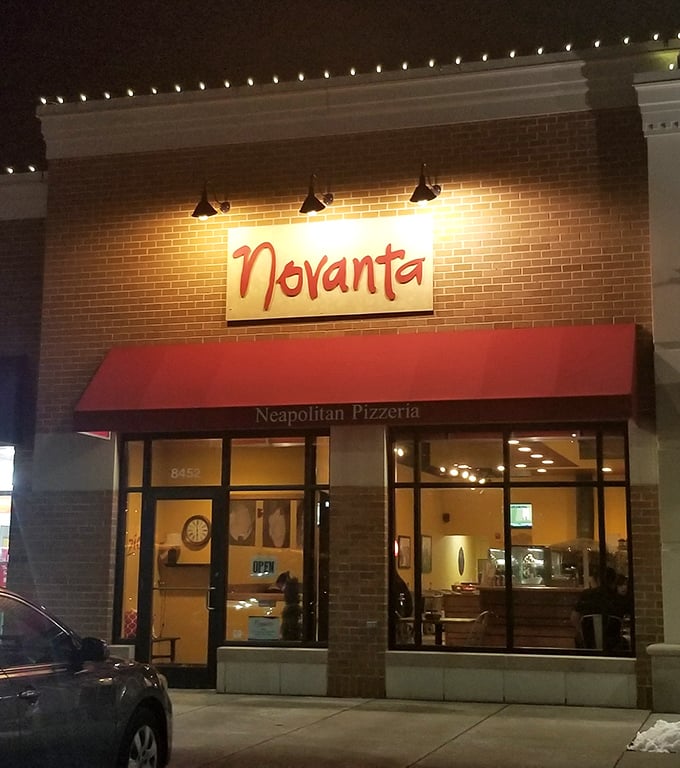 When evening lights hit just right, even modest storefronts reveal their delicious secrets within.