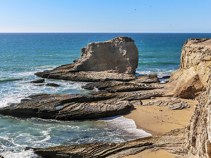 Dramatic rock formations stand guard at Panther Beach like ancient sentinels watching over their sandy kingdom.