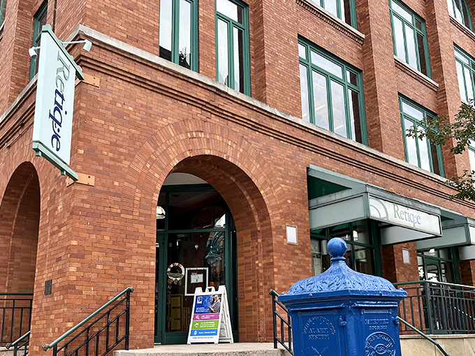 That blue mailbox stands guard outside Retique like a sentinel of style, silently judging your current outfit while promising better options inside.