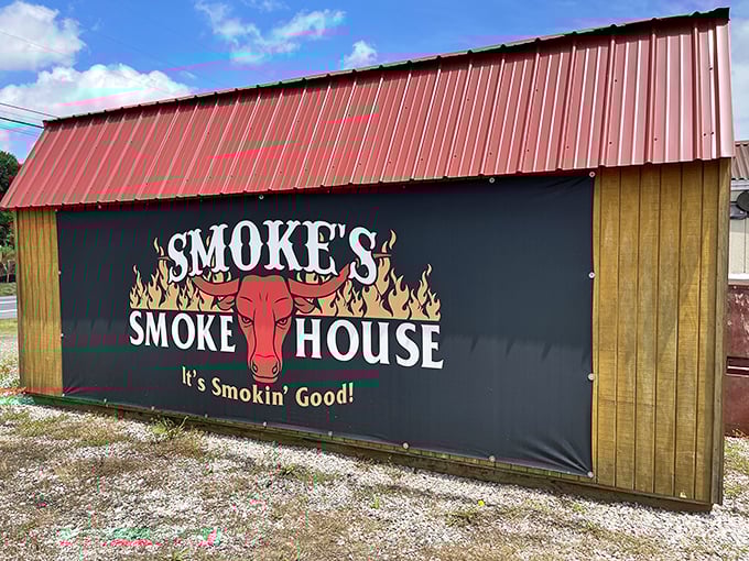 That red roof and smoky promise make this roadside gem impossible to resist on hungry days.