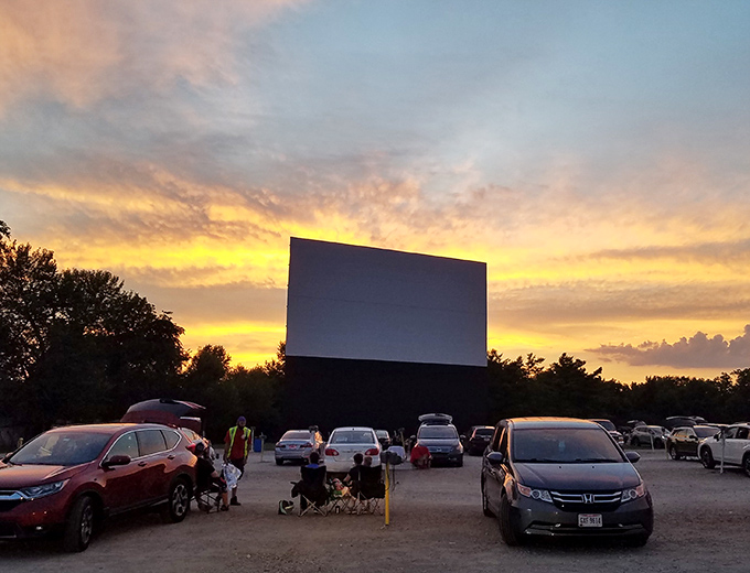 Cars gather like old friends at sunset, ready for another night of outdoor cinema bliss.