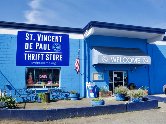 Welcome to thrift paradise! St. Vincent's cheery blue entrance with colorful planters feels like the gateway to a bargain hunter's dream.