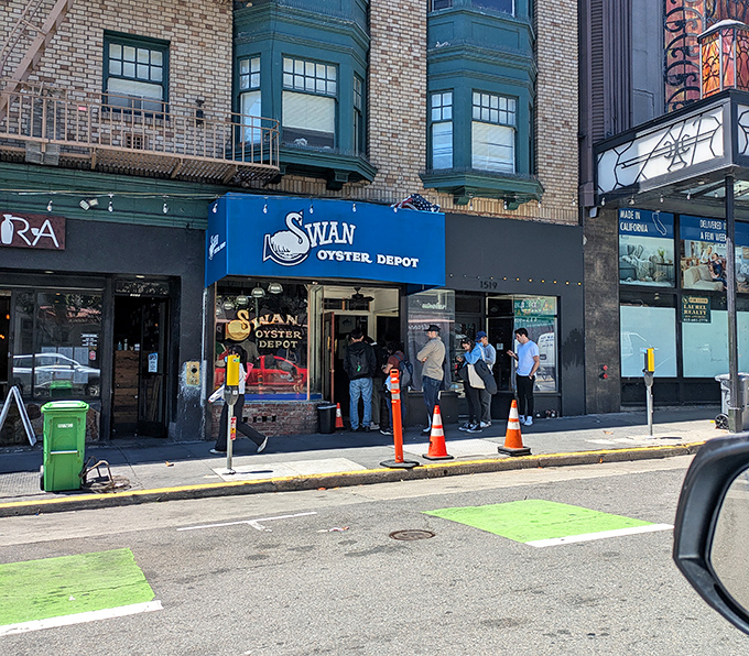 The blue awning beckons like a beacon for seafood lovers who understand that good things come to those who wait.