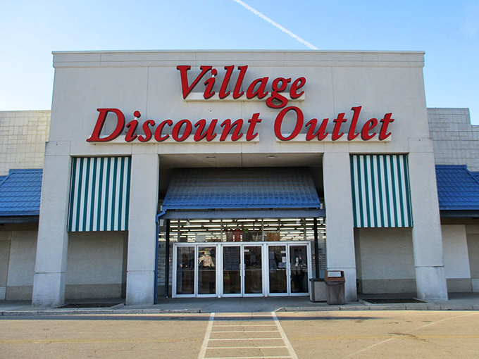 Village Discount Outlet's welcoming entrance beckons thrifters with the promise of endless aisles filled with secondhand gold.