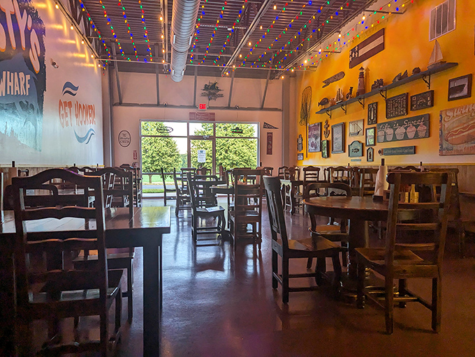 String lights twinkle overhead like stars above a boardwalk, while nautical treasures adorn sunny yellow walls. The dining room feels like a cheerful coastal escape.