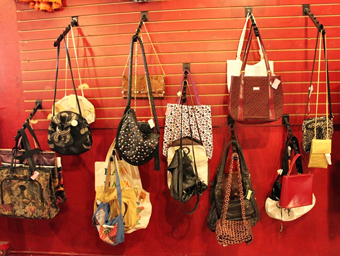 Handbags with past lives hang like fashion fruit, each one whispering stories of nights out, vacations taken, and compliments received in their previous chapters.