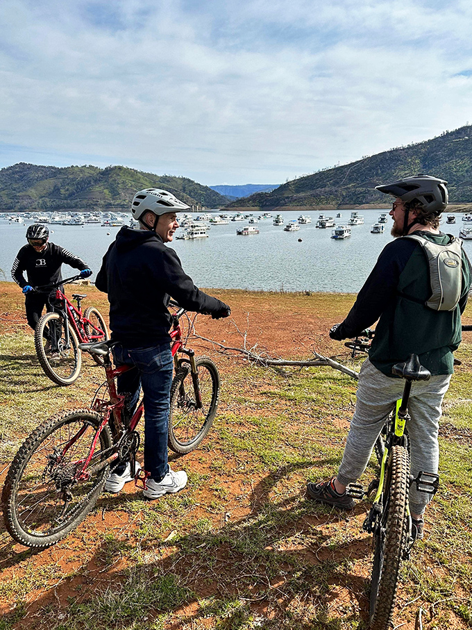 Mountain bikers pause to appreciate Lake Oroville's vastness. Nothing says "retirement done right" like discussing trail options with a backdrop that belongs on a calendar.