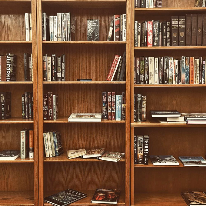 Literary time travel awaits between these wooden shelves, where forgotten bestsellers and classic tomes stand ready for their second chapter in someone's home library.