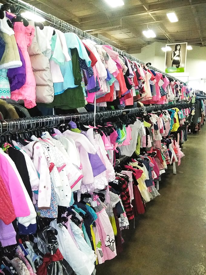 A rainbow explosion of children's clothing stretches toward infinity. One parent's outgrown items become another's back-to-school miracle.