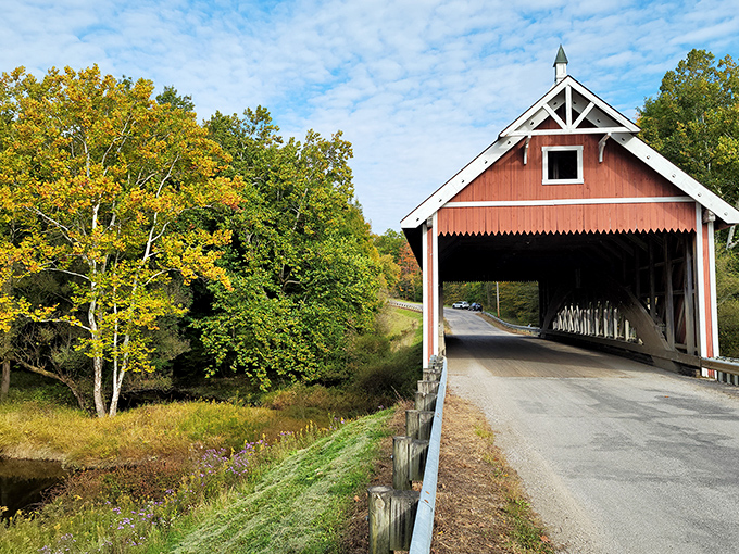 Autumn transforms this humble crossing into a masterpiece of color, where rustic architecture meets nature's seasonal paintbrush.