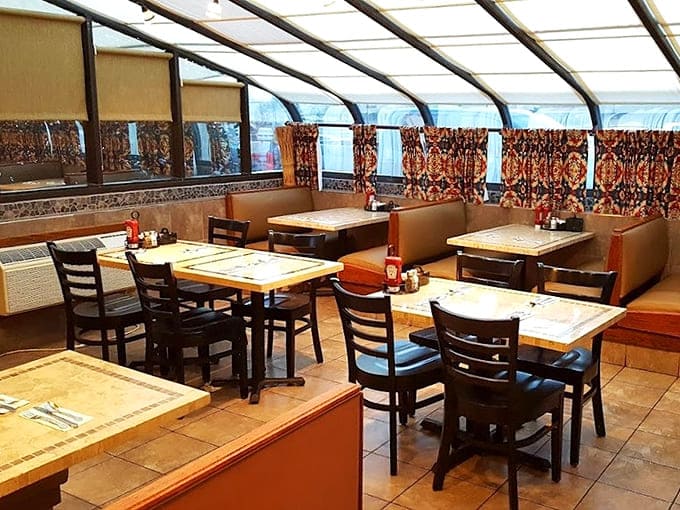 The sunroom dining area offers the perfect blend of coziness and light – like eating in your favorite aunt's house, if she were an exceptional cook.