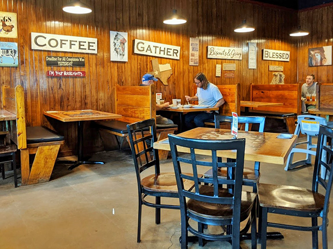 Wooden booths, rustic walls, and inspirational signs create that perfect "come as you are" atmosphere where coffee flows and conversation grows.