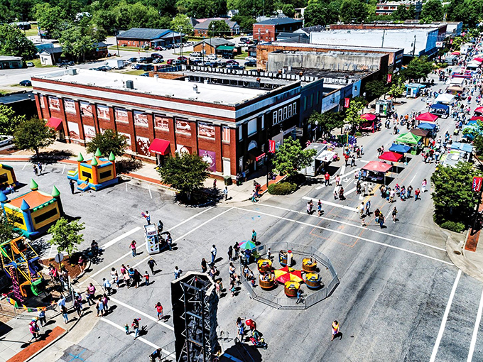 Festival day transforms downtown into a vibrant community gathering. Nothing says "small town America" quite like bouncy castles next to historic architecture.