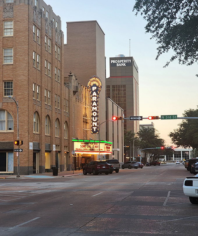 The historic Paramount Theatre's neon marquee lights up downtown Abilene like a beacon from another era, promising entertainment and nostalgia in equal measure.