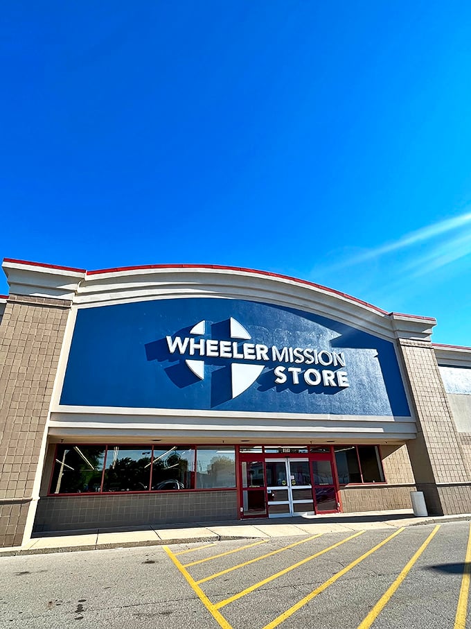 Under clear blue skies, the Wheeler Mission Store's distinctive facade invites shoppers to discover what lies beyond those red-trimmed doors.