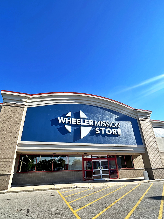 Under clear blue skies, the Wheeler Mission Store's distinctive facade invites shoppers to discover what lies beyond those red-trimmed doors.