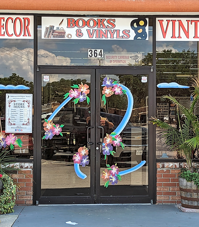 Colorful floral decorations frame the entrance doors, offering a cheerful welcome to this wonderland of vintage finds and forgotten treasures.