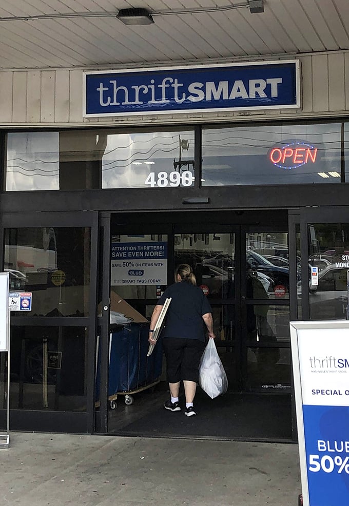 The promise of "OPEN" and 50% off with colored tags beckons like a siren song to thrift enthusiasts ready to embark on a treasure hunt.