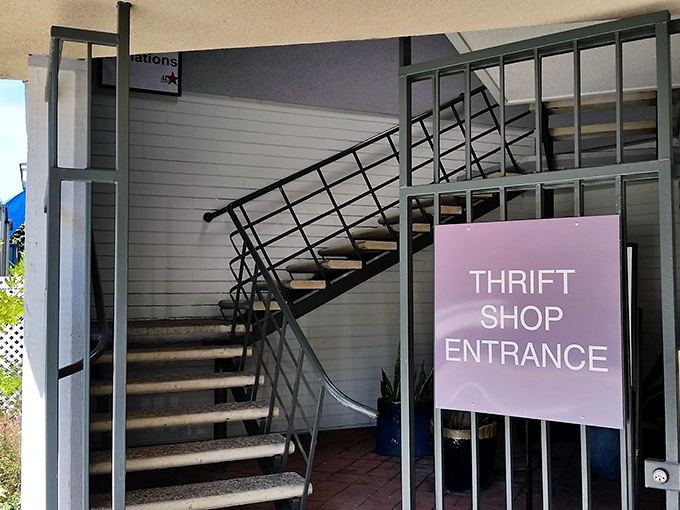 The stairway to secondhand heaven beckons with a simple sign. Like the entrance to Narnia, but instead of talking lions, you'll find talking points for your wardrobe.