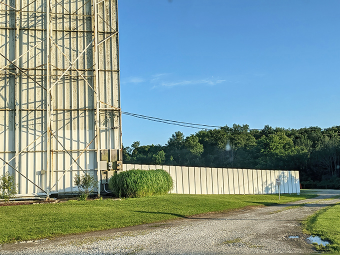 Those classic entrance pillars stand like sentinels of simpler times, welcoming movie lovers to their outdoor cinema sanctuary.