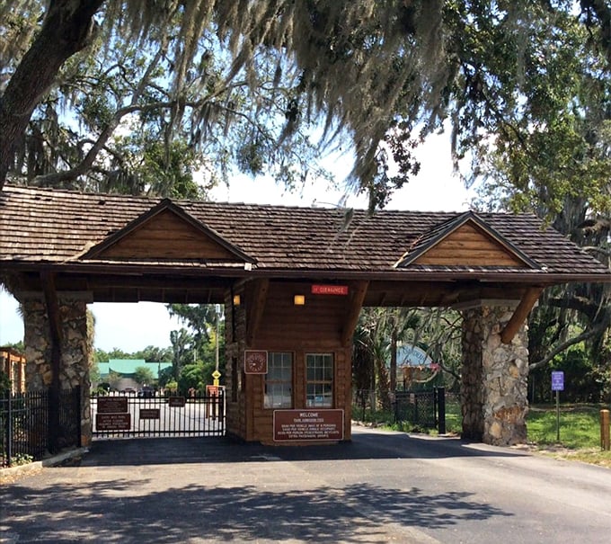 This charming rustic entrance could be the gateway to Narnia. The shingled roof and stone pillars whisper tales of Depression-era craftsmanship.