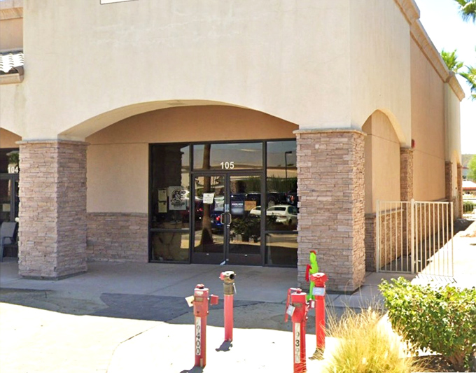 Palm trees stand sentinel at this thrift store entrance, where the automatic doors might as well have a sign reading "Abandon budget, all ye who enter here."