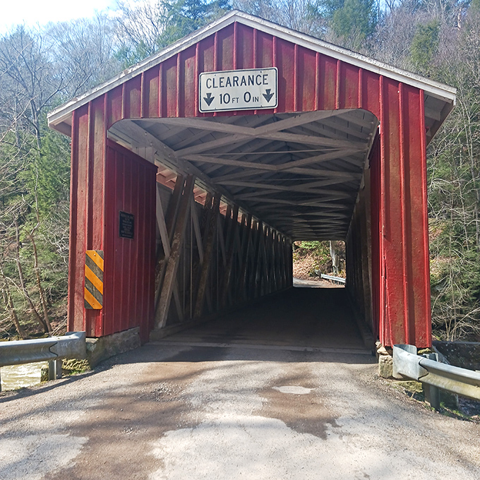 "Mind your head!" warns the clearance sign, a humble reminder that this historic passage was built for horse-drawn carriages, not your cousin's monster truck.