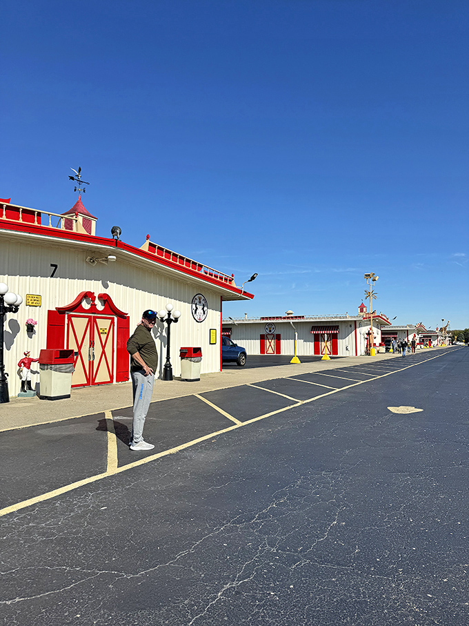 A shopper contemplates his next move outside Building 7, where the distinctive red trim and weathervane hint at the treasures housed within these market halls.