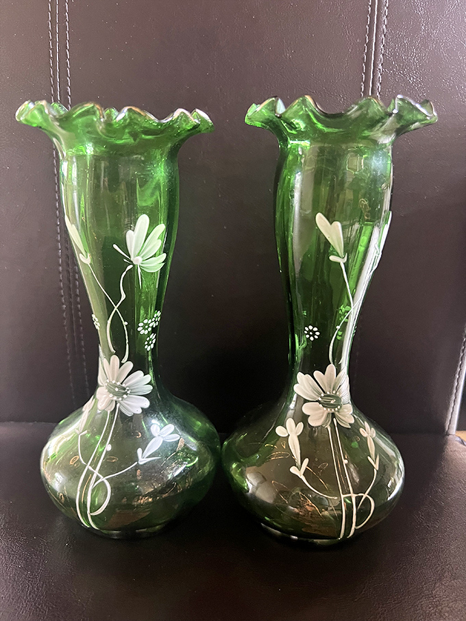 These emerald glass vases with delicate floral designs aren't just vintage finds&mdash;they're conversation pieces waiting to grace someone's mantel for a fraction of retail price.