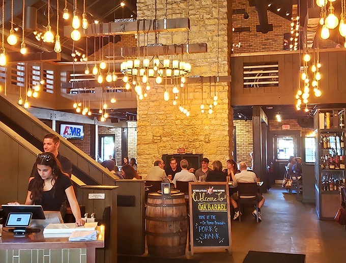 Edison bulbs dance overhead like fireflies in a stone and wood cathedral dedicated to the worship of good food and better company.